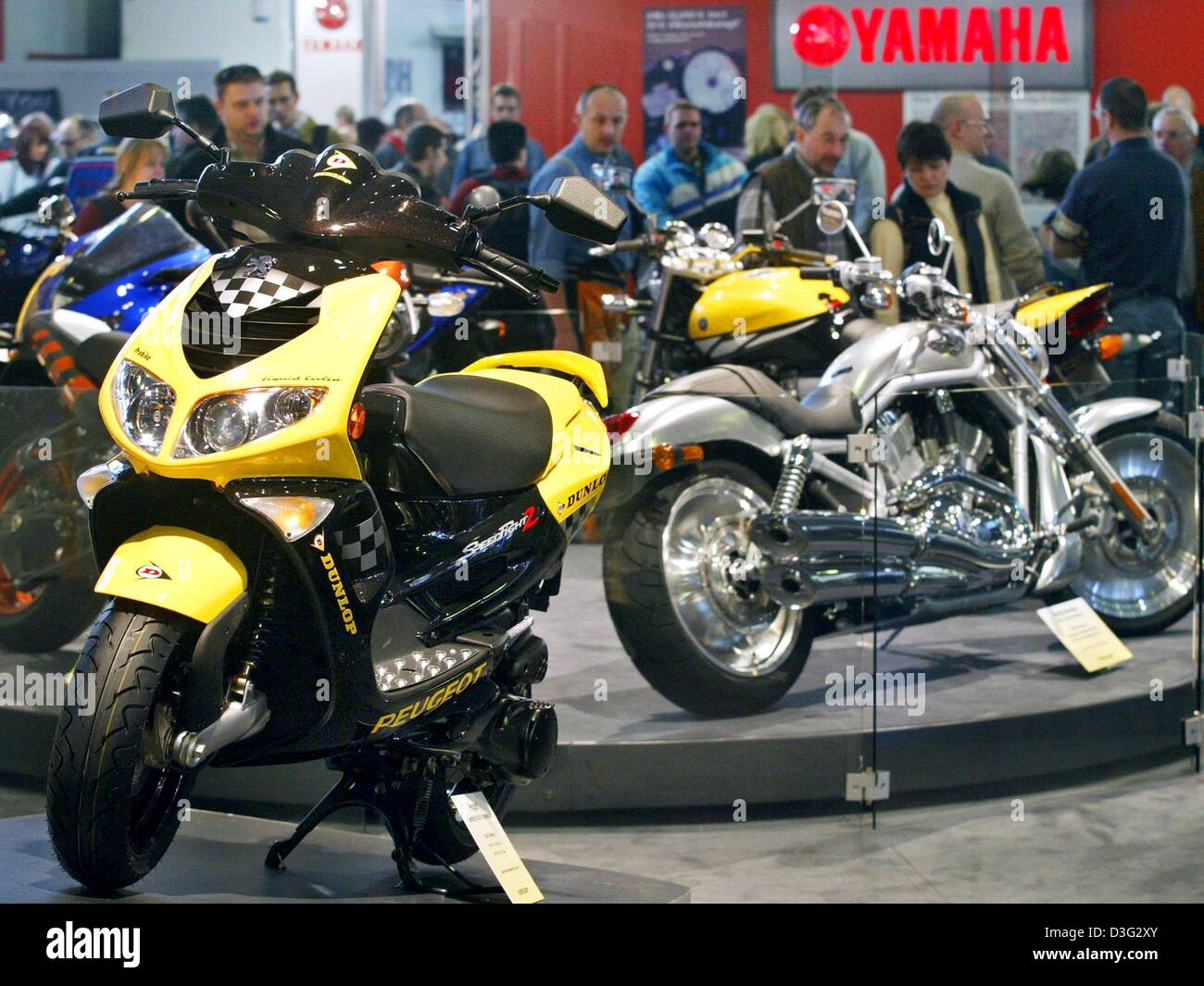 (dpa) - Visitors look at motorbikes at the 19th international motorbike ...