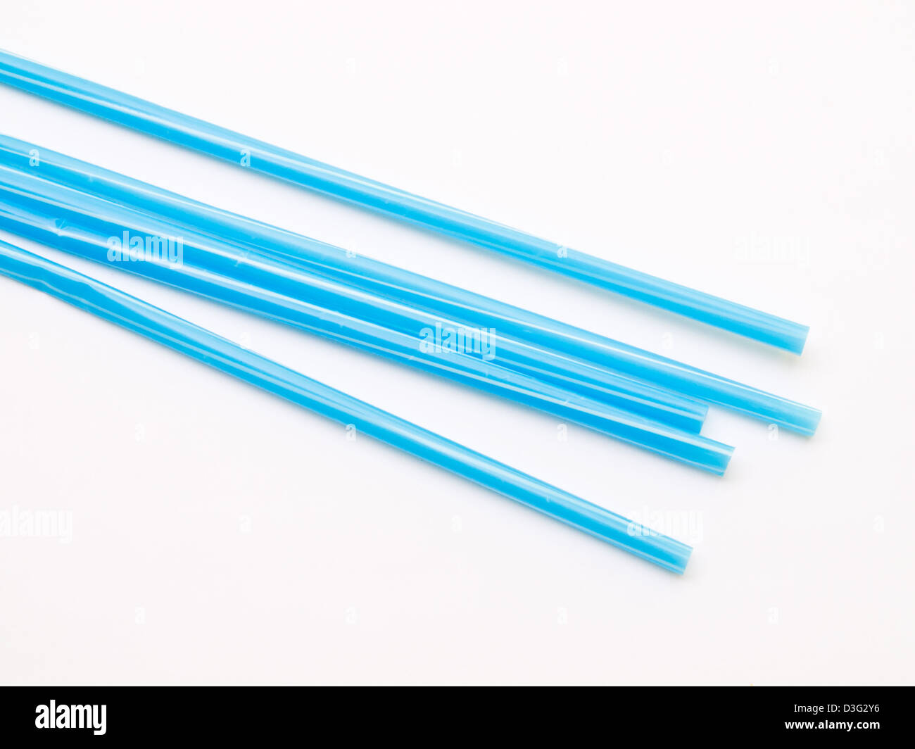 Light blue straws isolated on white background Stock Photo - Alamy