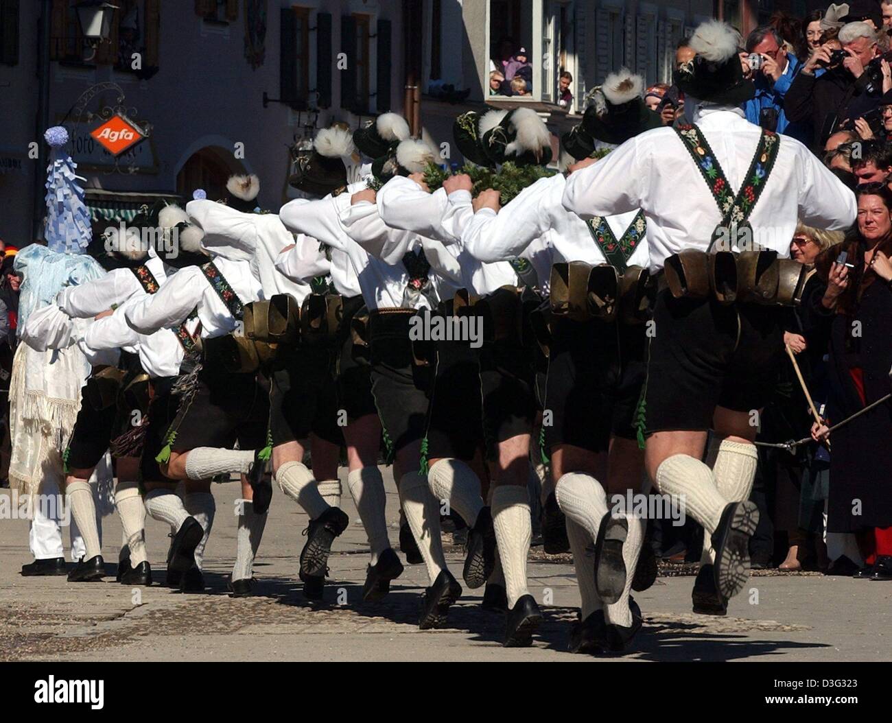 (dpa) - Masked men clad in identical Bavarian lederhosen (leather ...