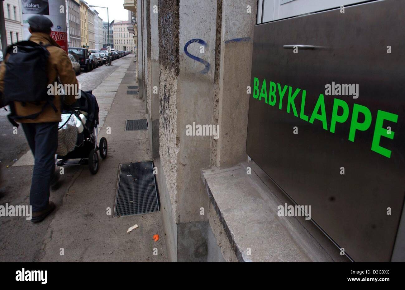 (dpa) - A man pushing a baby stroller walks past a so-called ...