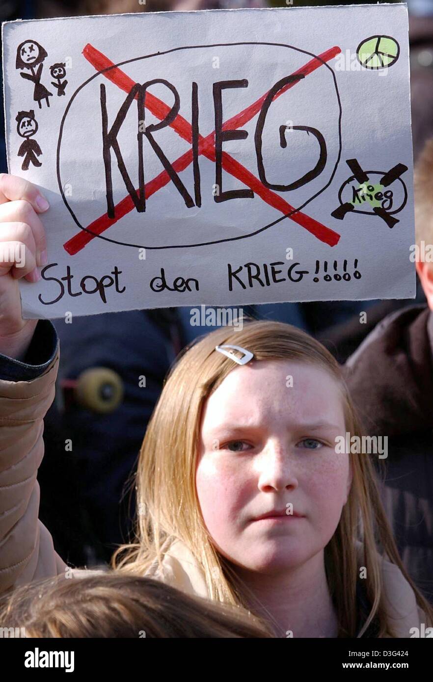(dpa) - A student holds up a small, handwritten poster which reads ...