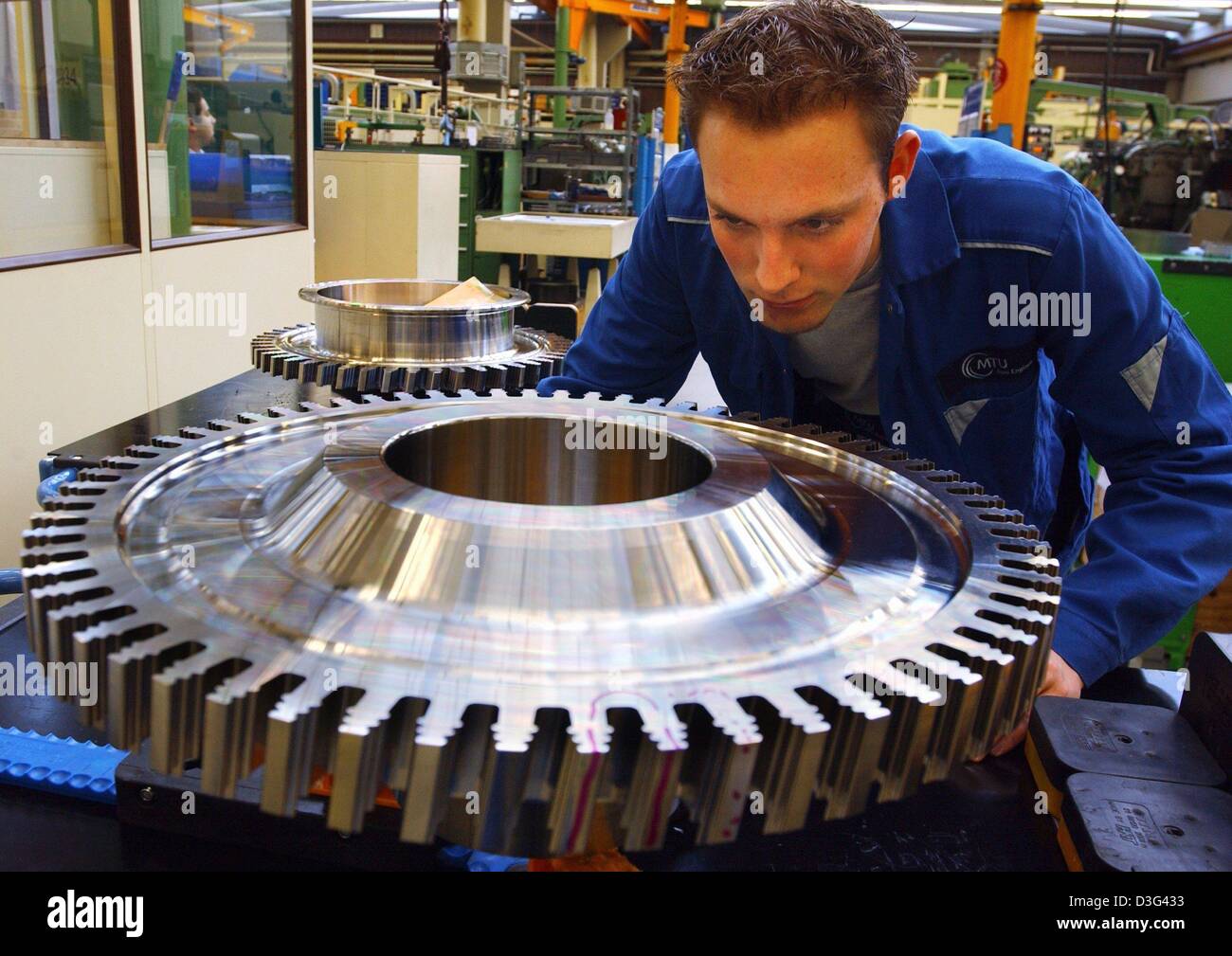 (dpa) - An employee checks the disk of an aircraft turbine at MTU Aero ...