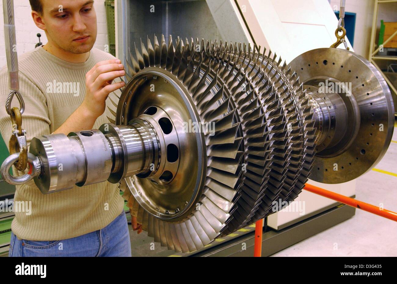 (dpa) - An employee repairs the compressor of a Eurofighter engine at ...