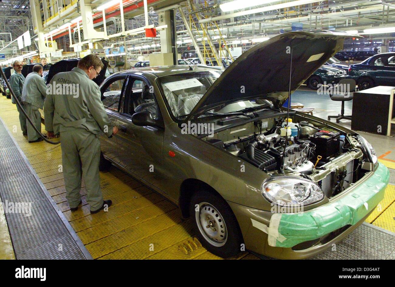 (dpa) - Workers control a newly made car in a factory of the South ...