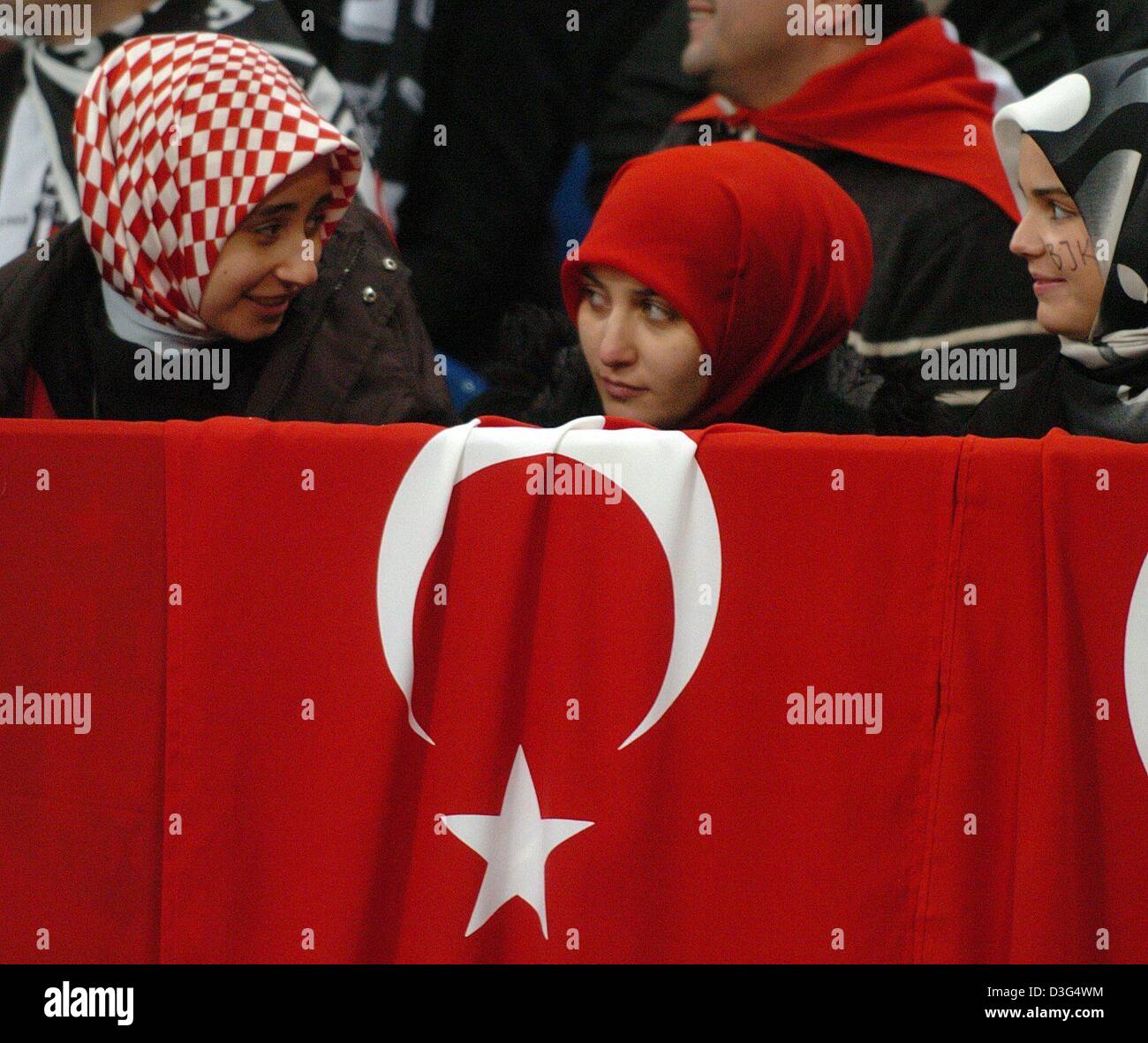 (dpa) - Female Turkish soccer fans sit in the stands behind the Turkish ...