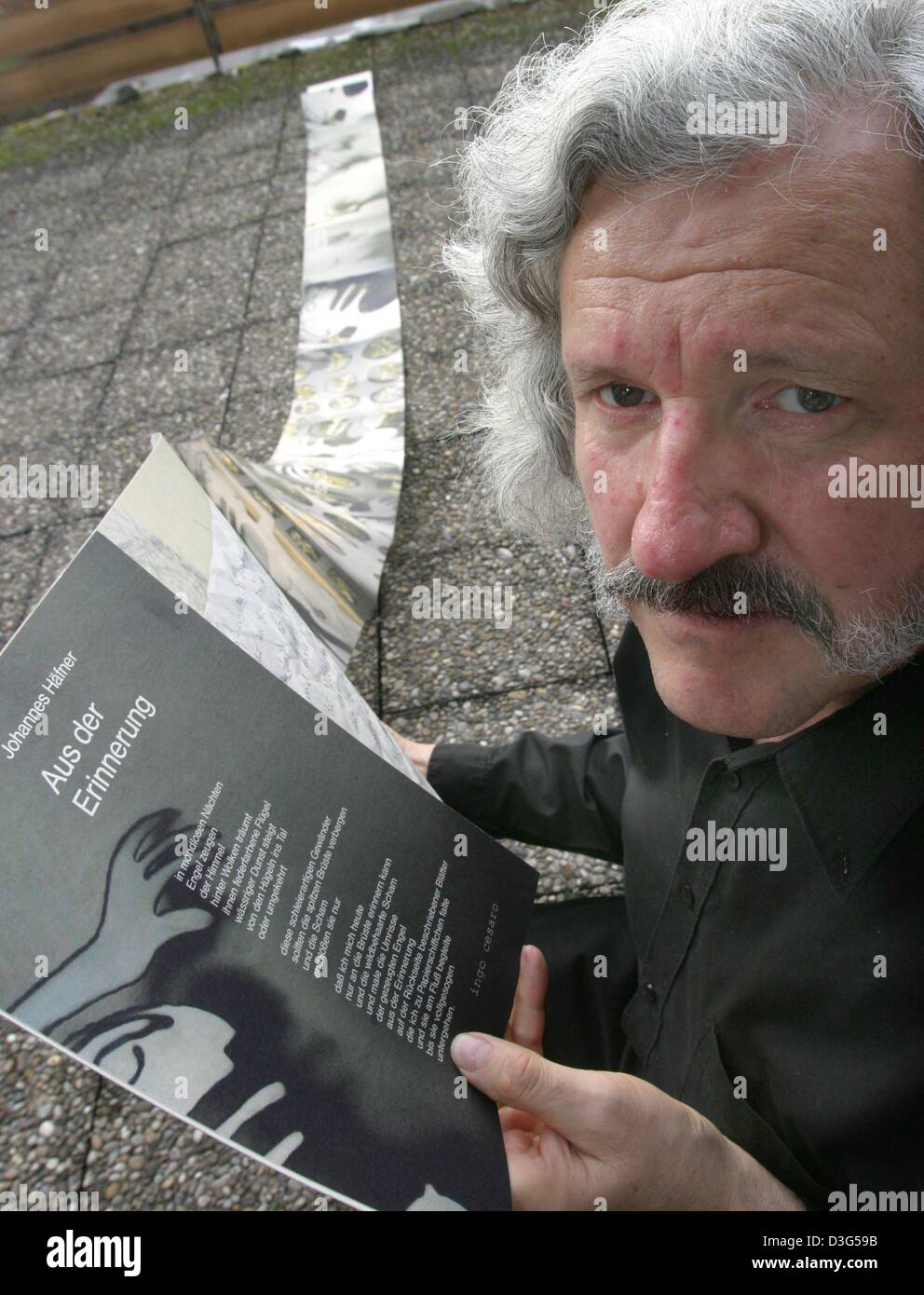 (dpa) - Artist Ingo Cesaro holds in his hands the seven metre long book ...