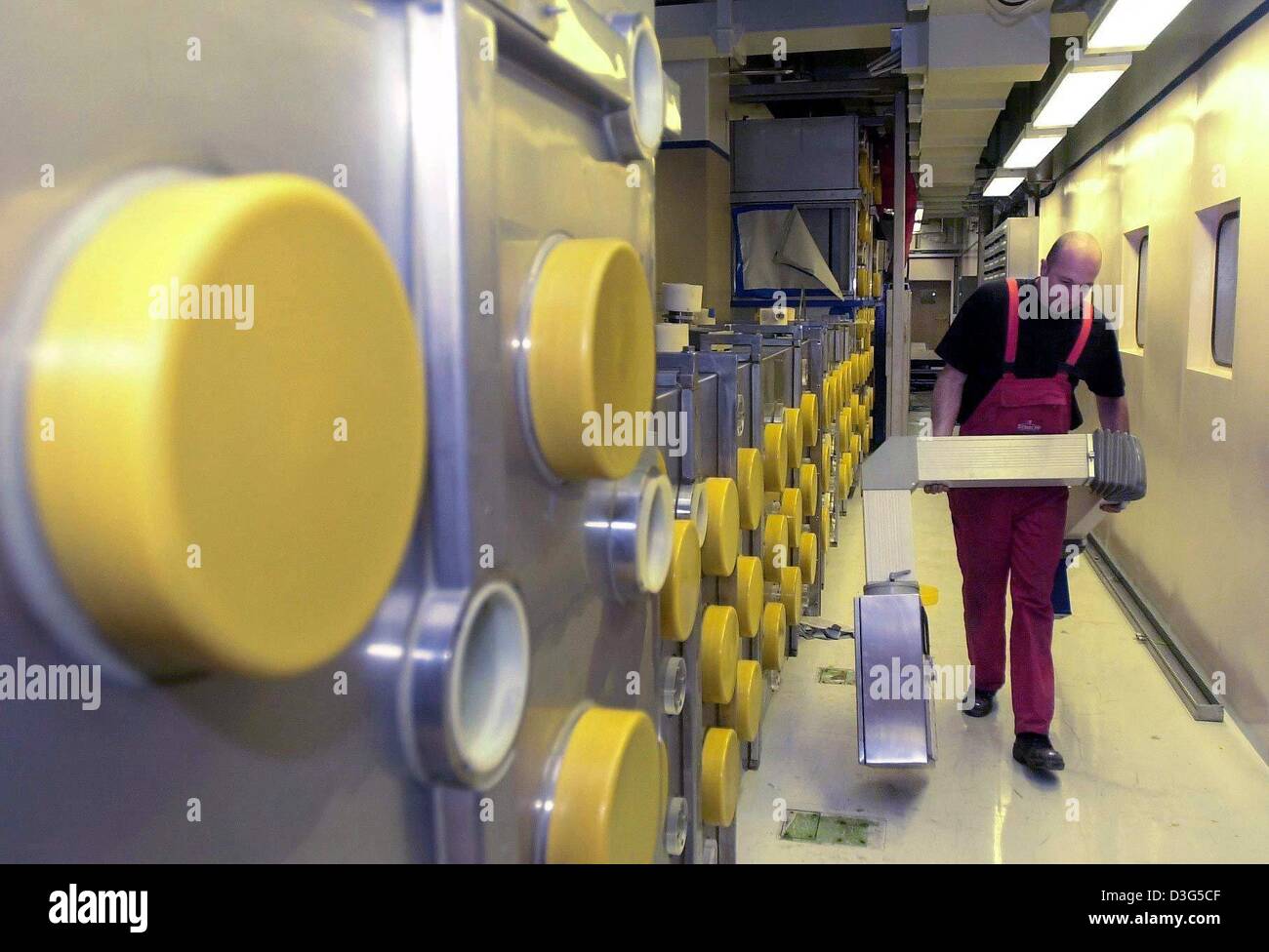 (dpa files) - A worker carries parts of unused plutonium pellets at the ...
