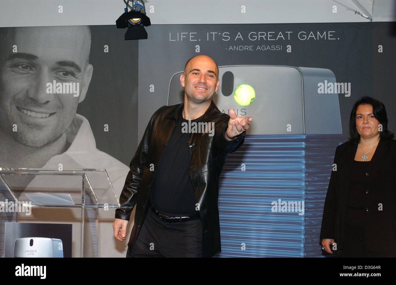 (dpa) - US tennis pro Andre Agassi (C) stand in front of an oversized ...
