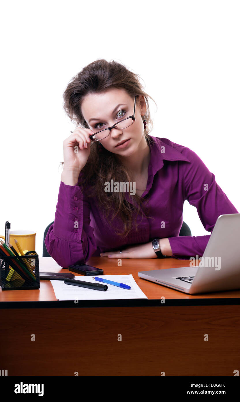 Businesswoman looking throu her glases at a table isolated on white ...