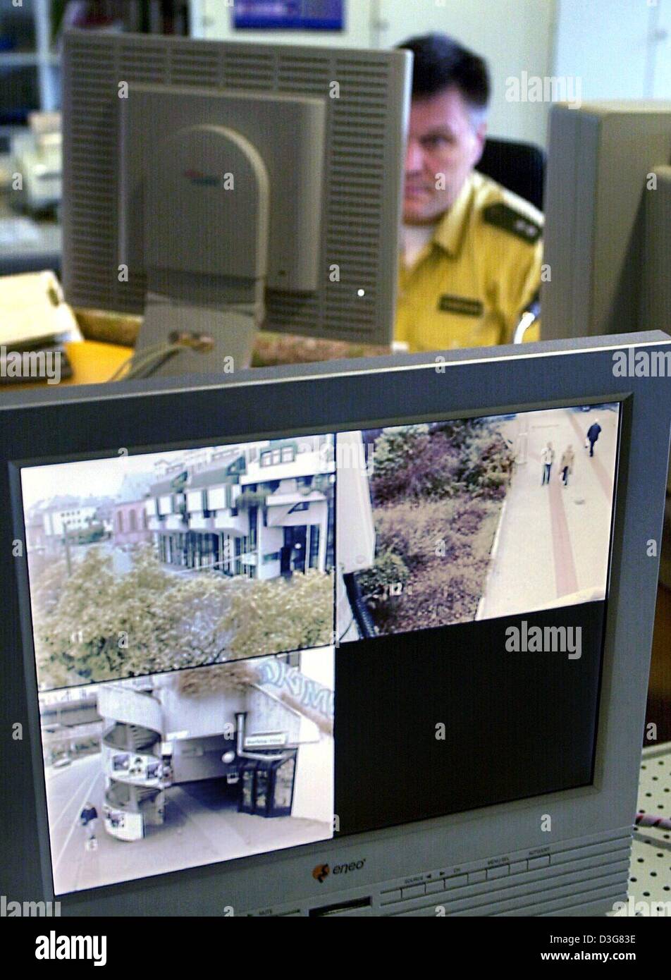 (dpa) - A police officer monitors the screens of the video surveillance ...