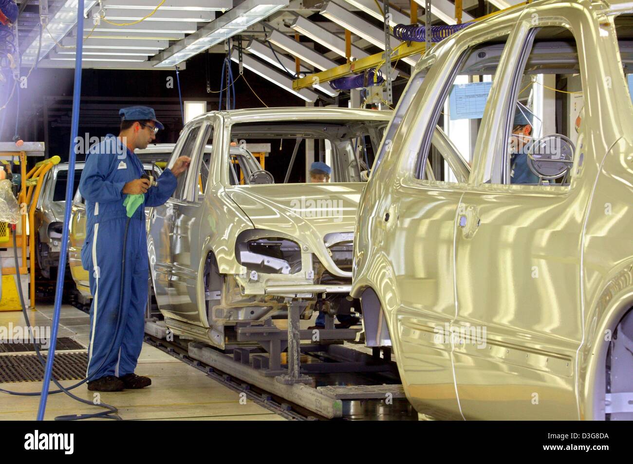 (dpa files) - An employee works on the car body of a M Class Mercedes ...