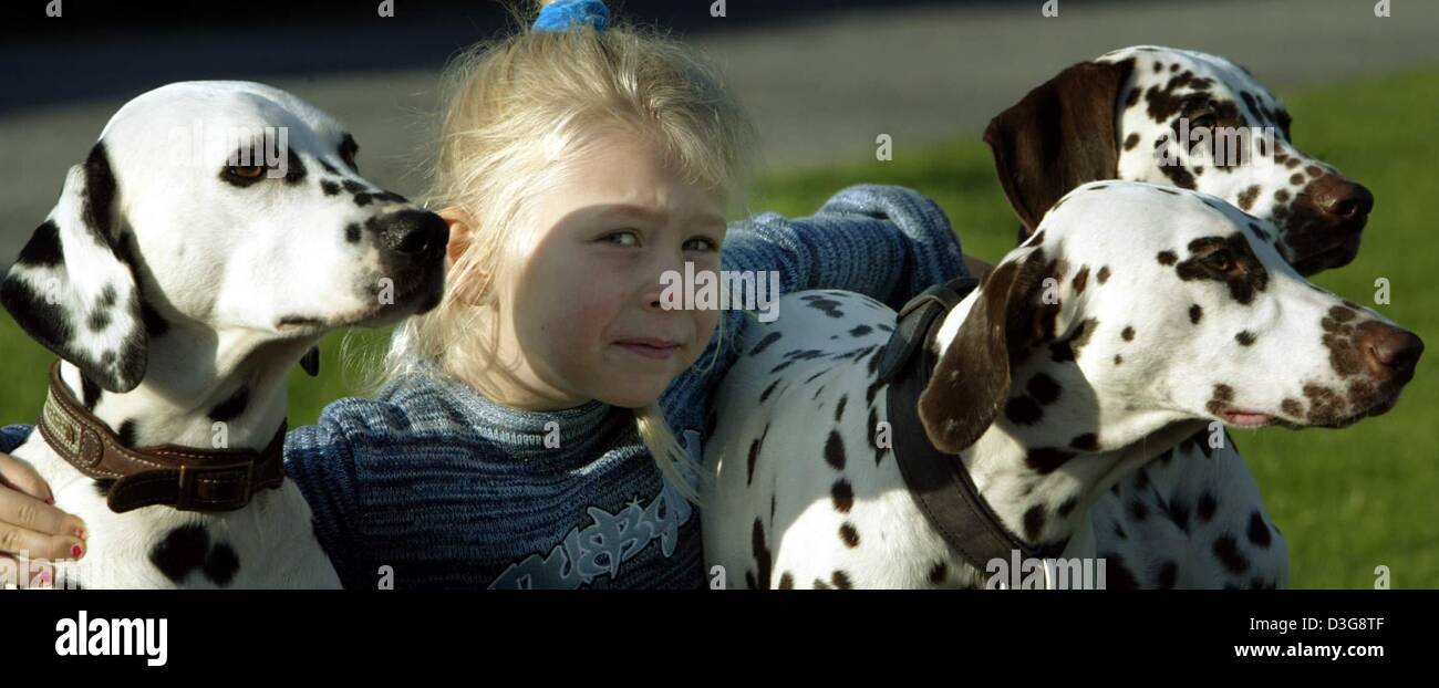 (dpa) - Ann-Kathrin poses next to three Dalmatian dogs during a dog ...