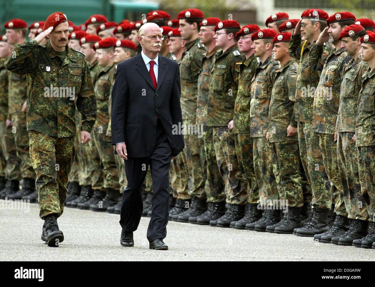 (dpa) - German defence minister Peter Struck walks past a line of ...