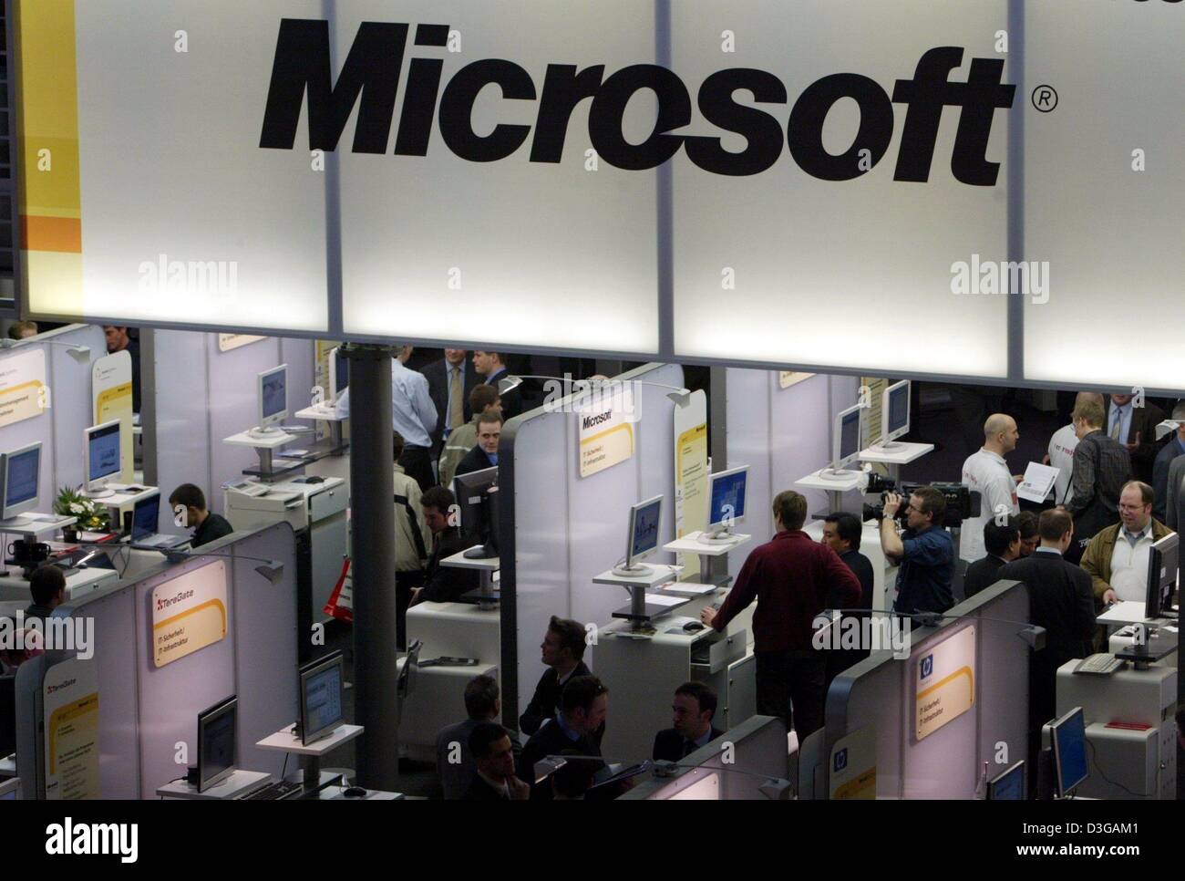 (dpa) - Visitors look around at the Microsoft stand at the world's ...