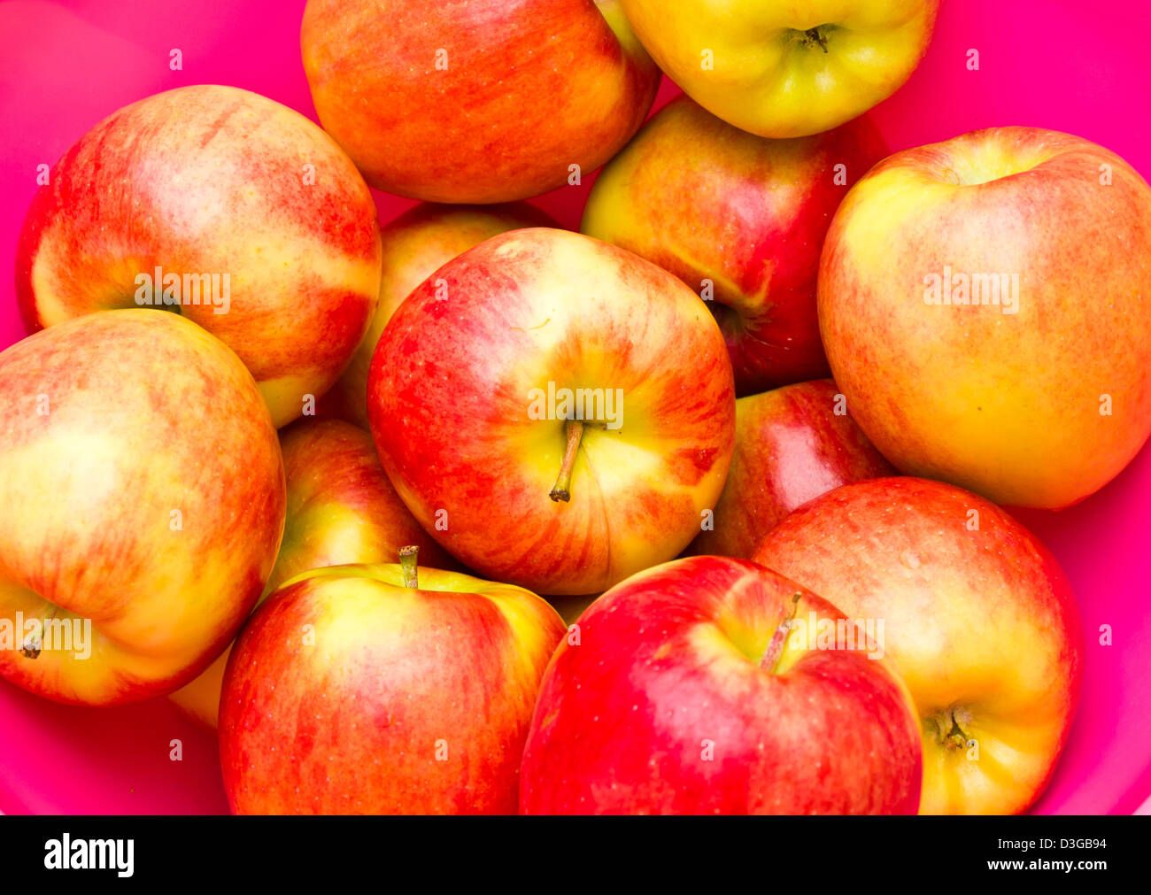 Red apples isolated on pink background Stock Photo - Alamy