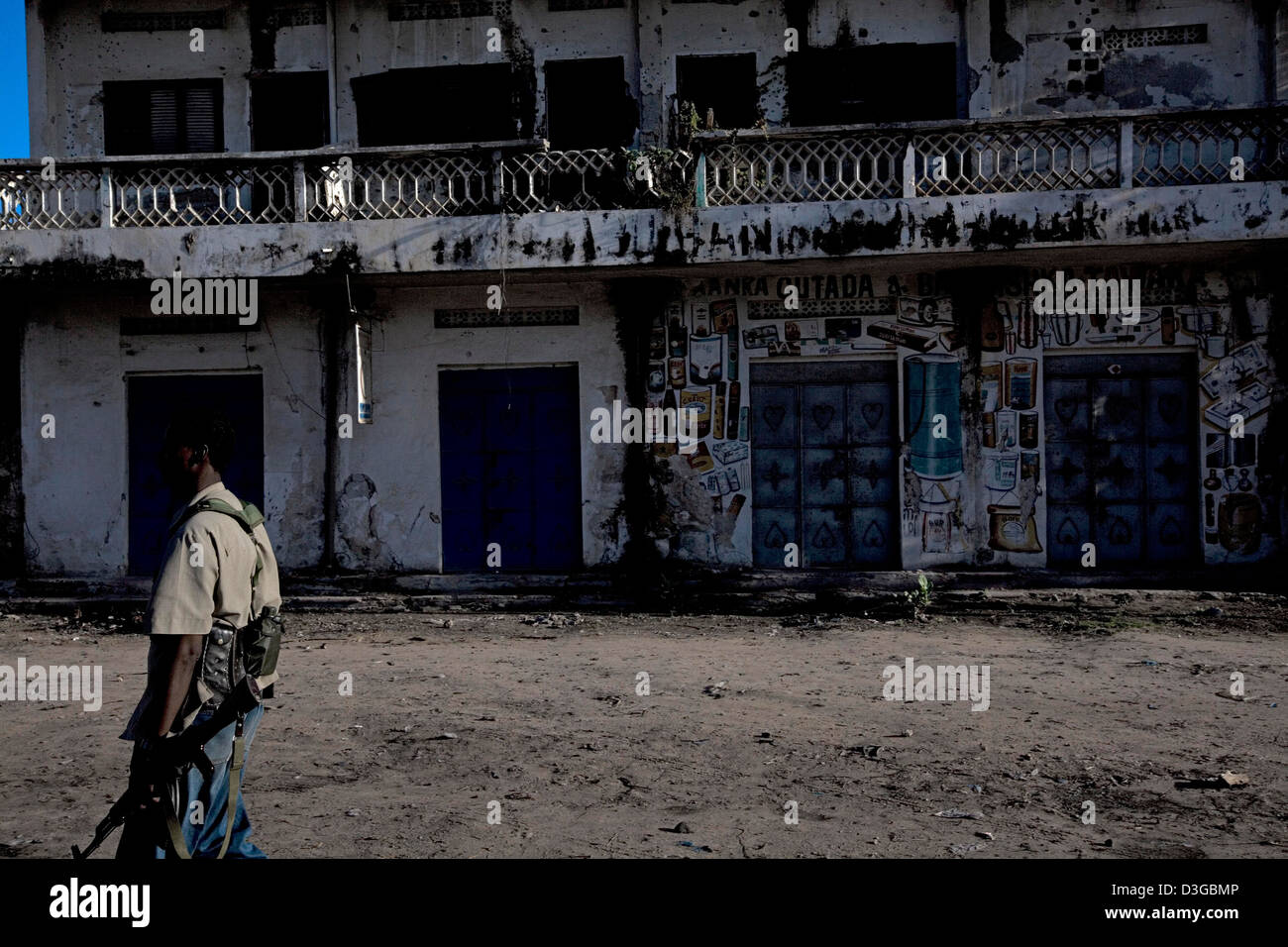 An armed guard on patrol on the deserted streets of downtown Mogadishu ...