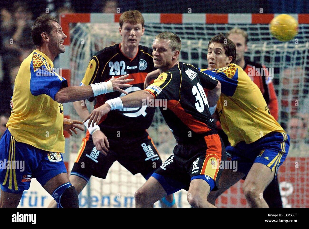 (dpa) - German handball players Volker Zerbe (2nd from L) and Klaus ...