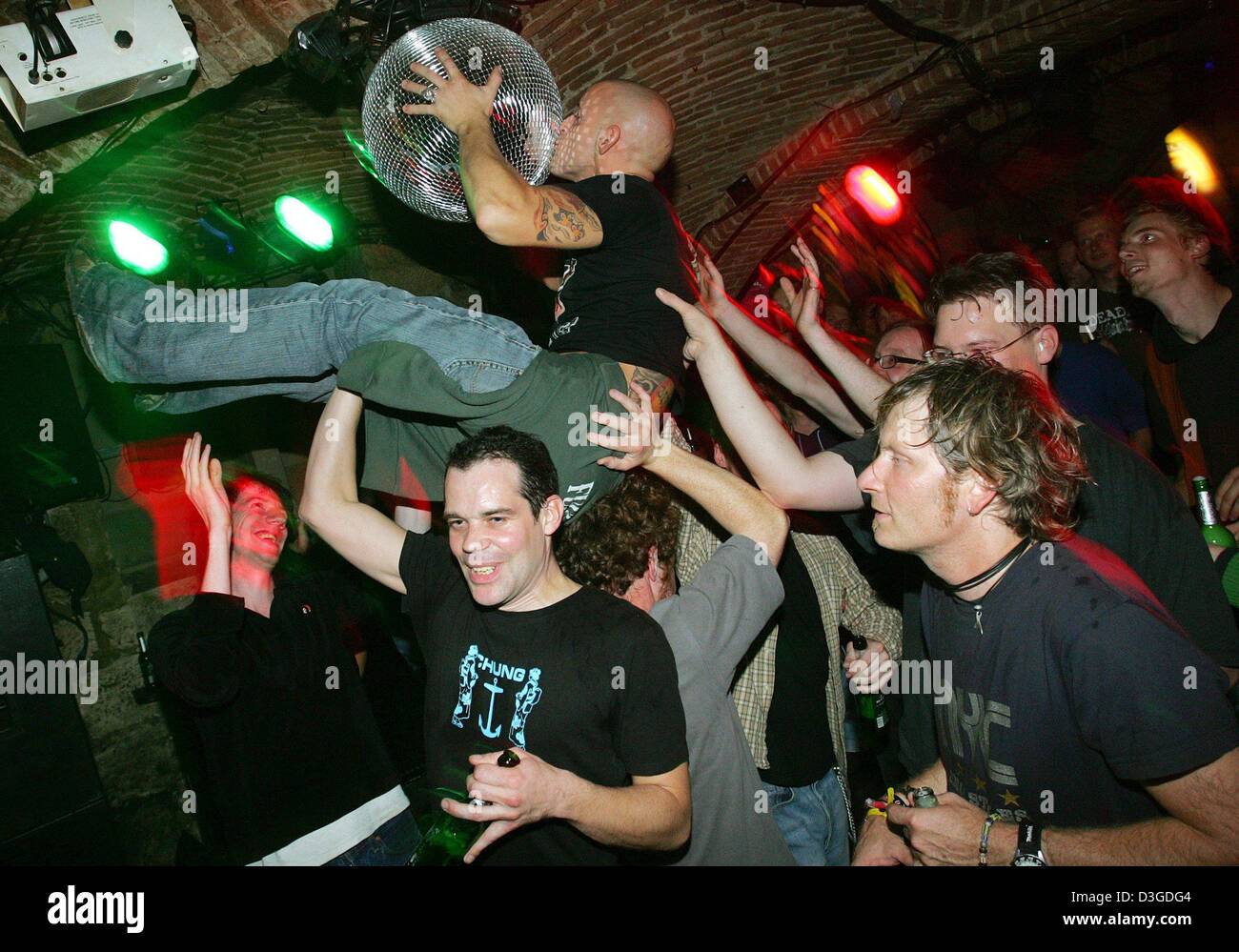 (dpa) - A punk rock fan kisses a disco ball while stagediving during a ...