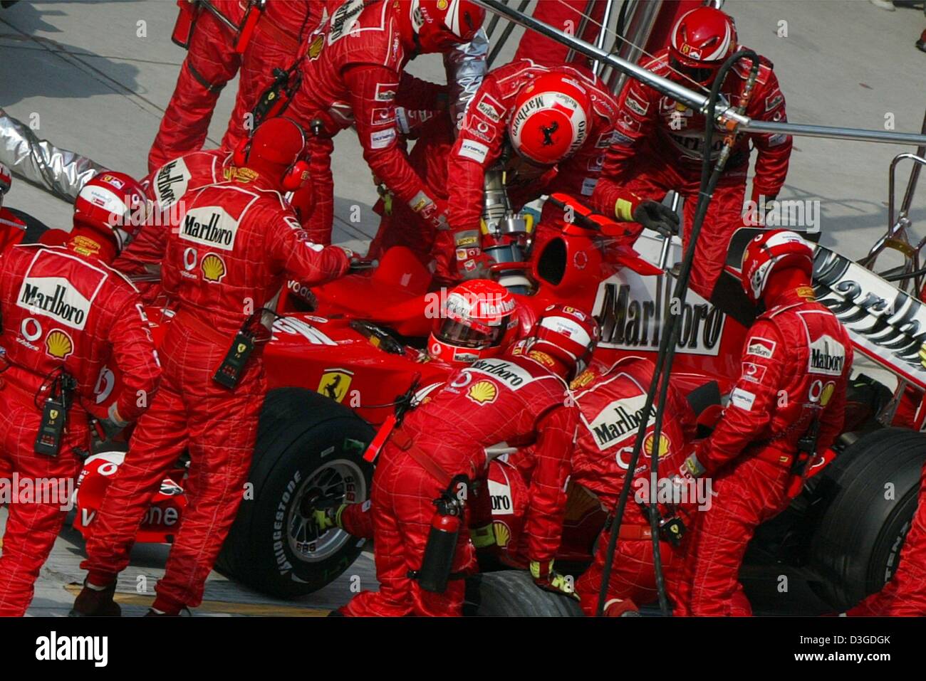 (dpa) - Ferrari mechanics hurry during Michael Schumacher's pit stop ...