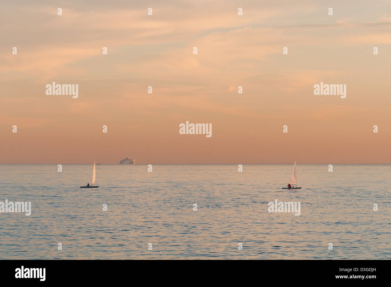 Sailboats and a cruise ship at distance Stock Photo - Alamy