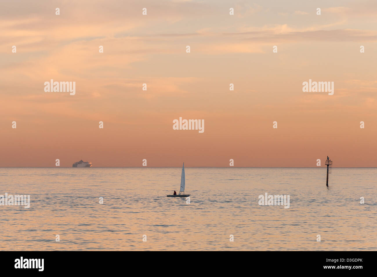 Sailboats and a cruise ship at distance Stock Photo - Alamy