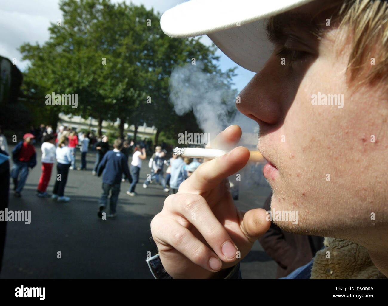 (dpa) - A student smokes a cigarette in a designated smoking area at a ...
