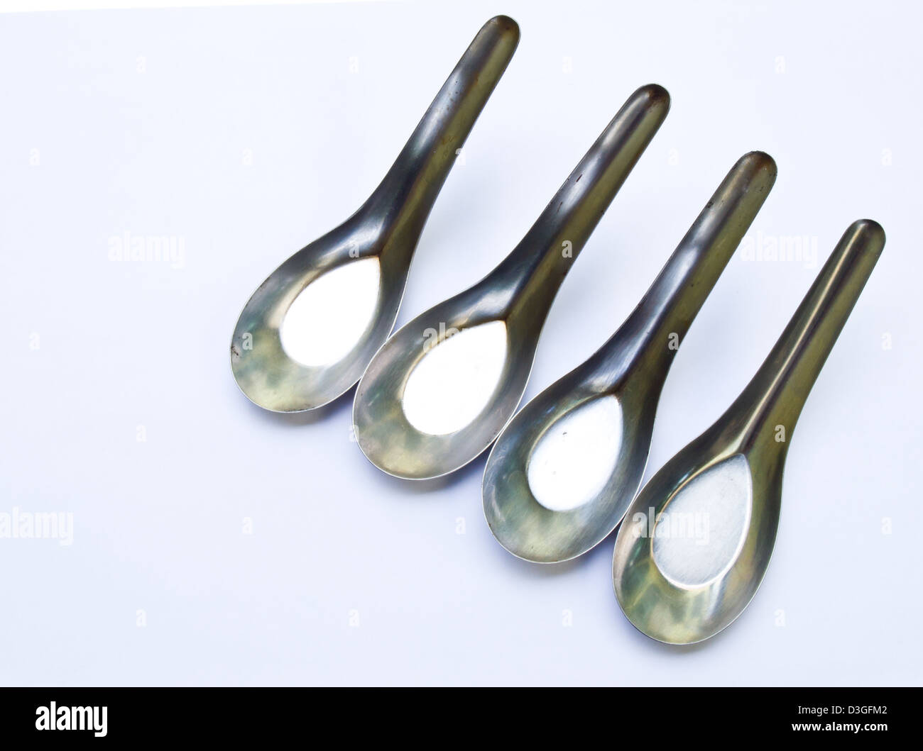 Used stainless steel spoons isolated on white background Stock Photo ...