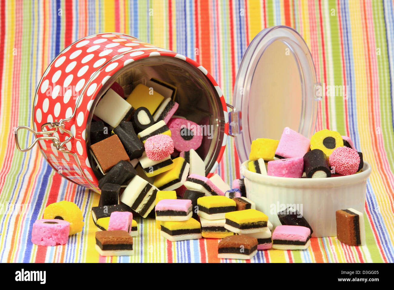 Liquorice sweets in colourful containers against a colourful background ...