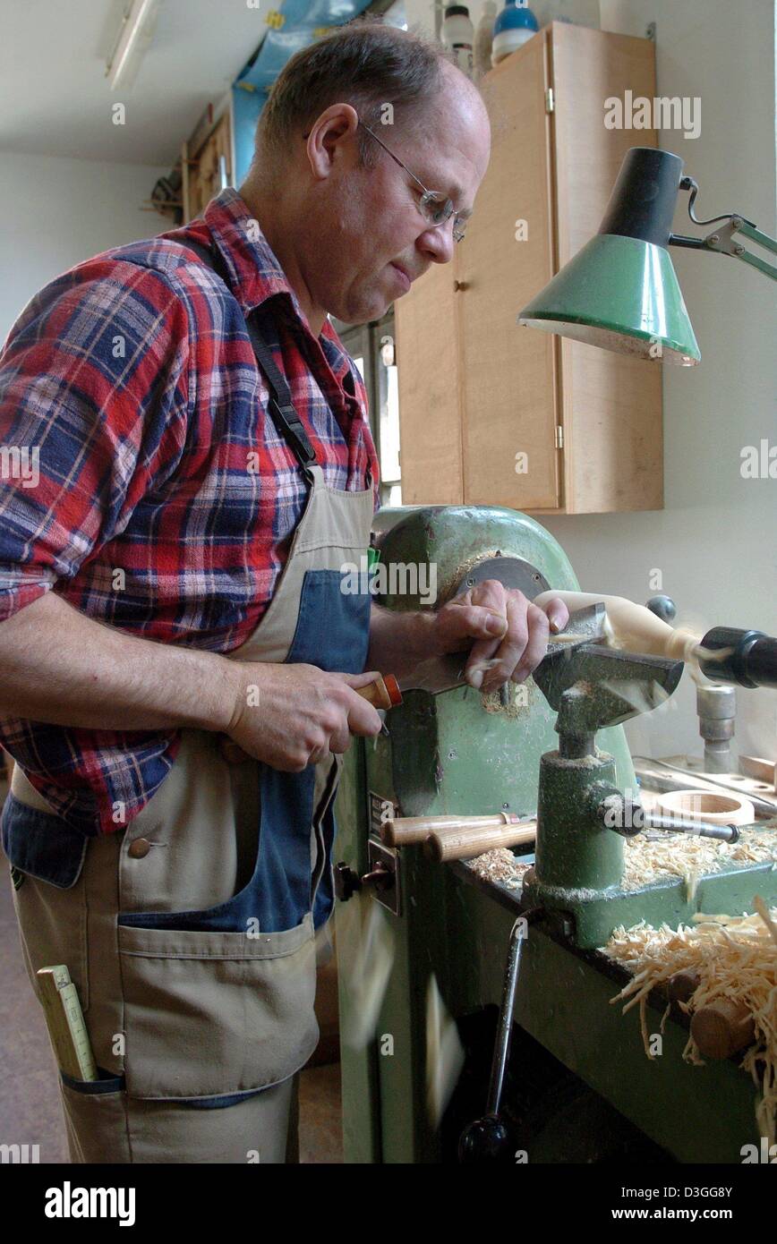 (dpa) - Lathe-turner Kai Simonsen works on a piece of wood with a ...