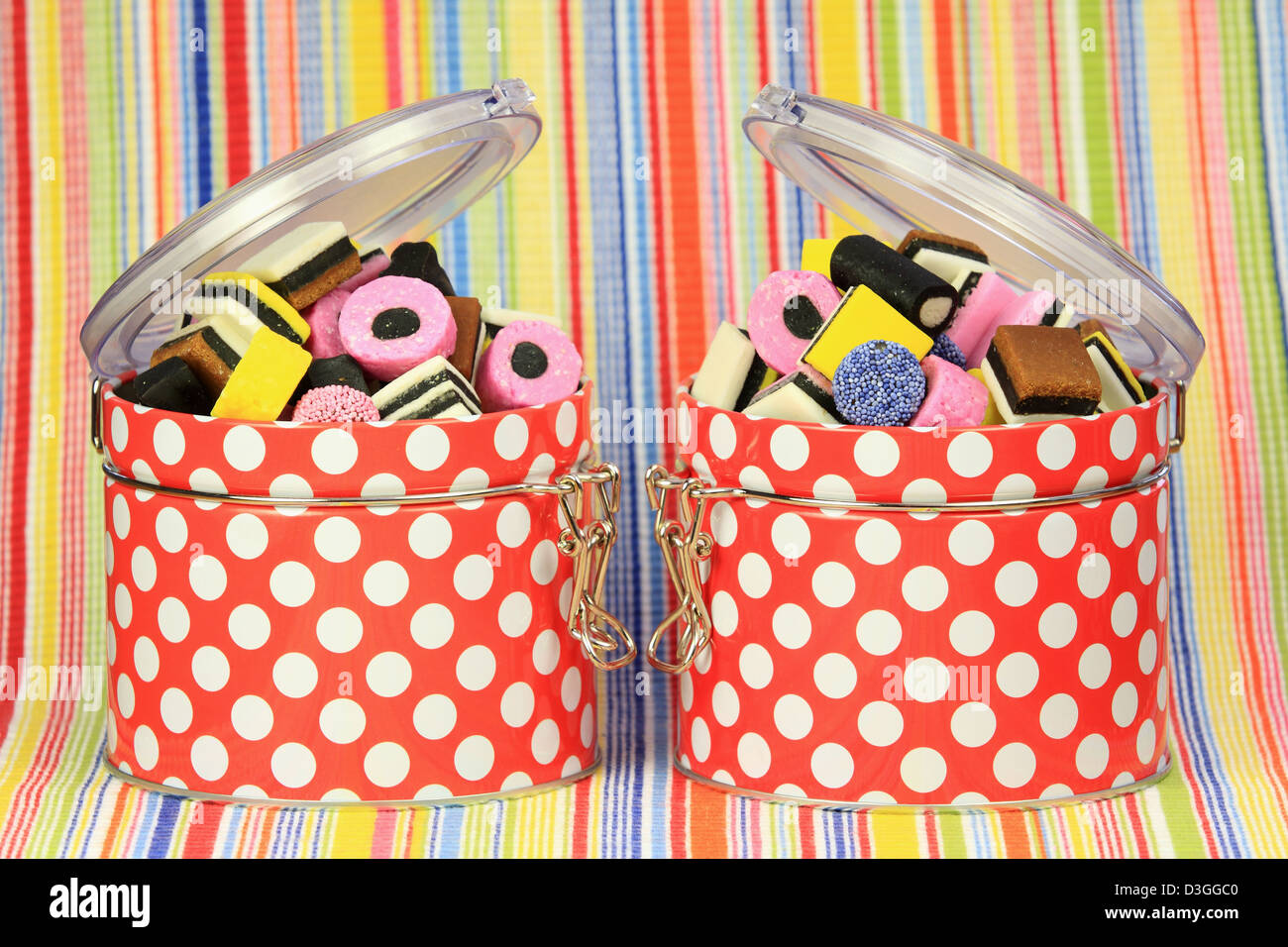 Liquorice sweets in colourful containers against a colourful background ...