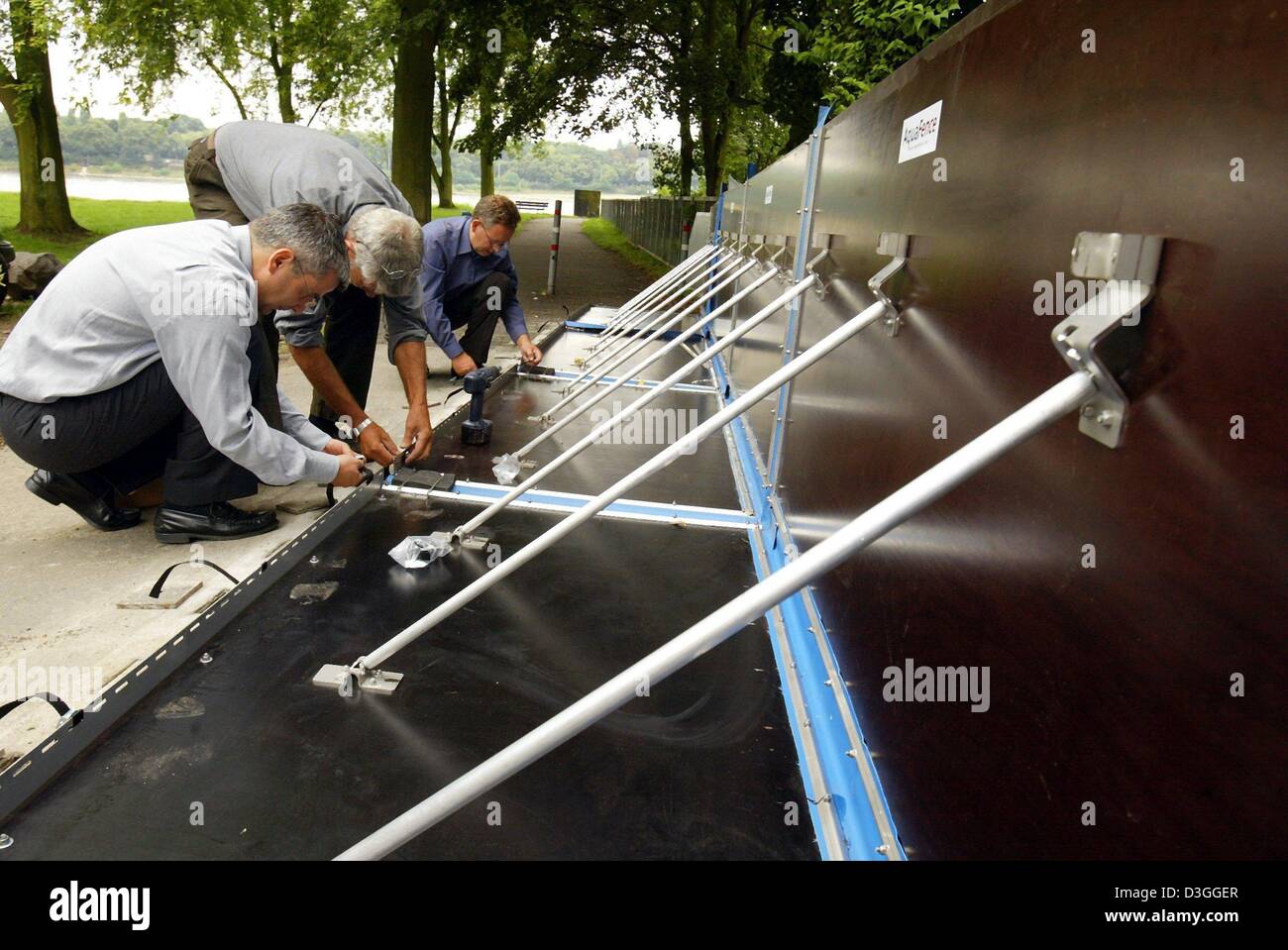 (dpa) - Three members of the flood protection unit Cologne assemble a ...