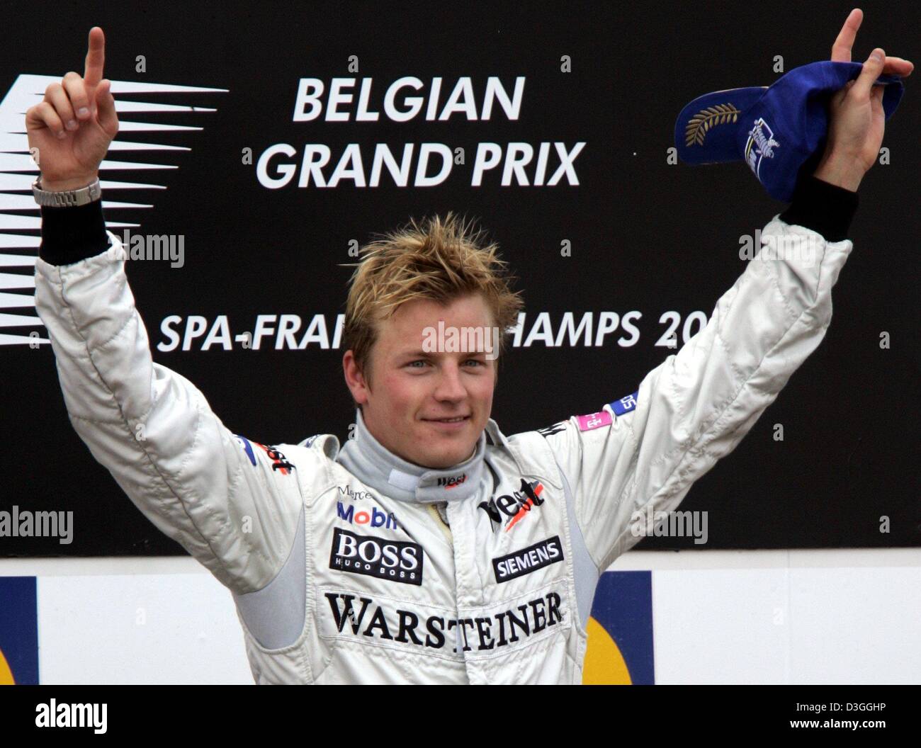 (dpa) - Kimi Raeikkoenen (McLaren-Mercedes) celebrates on the podium ...