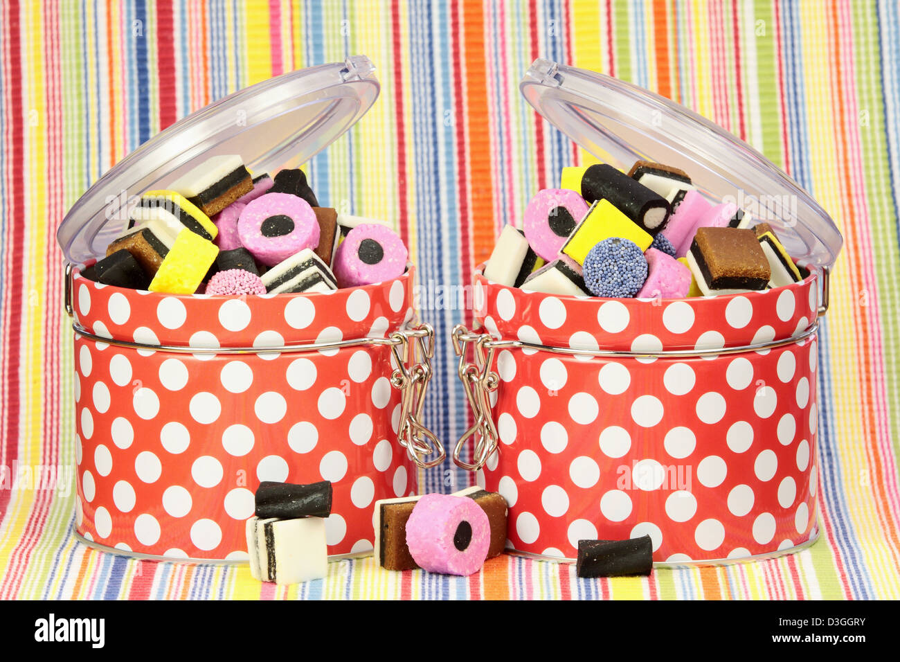 Liquorice sweets in colourful containers against a colourful background ...