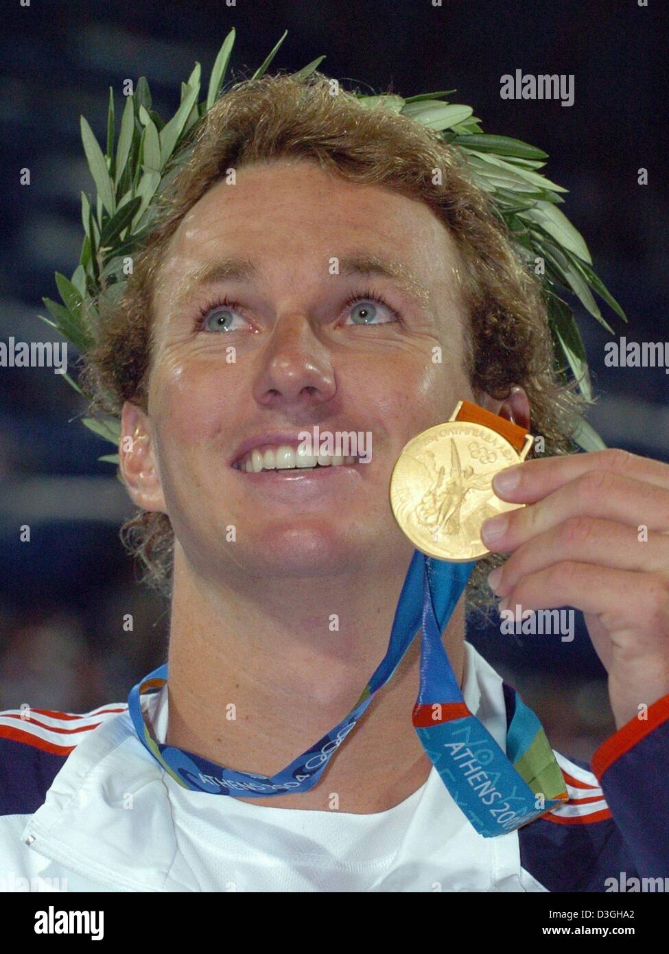 (dpa) - Aaron Peirsol from the USA shows his gold medal after winning ...
