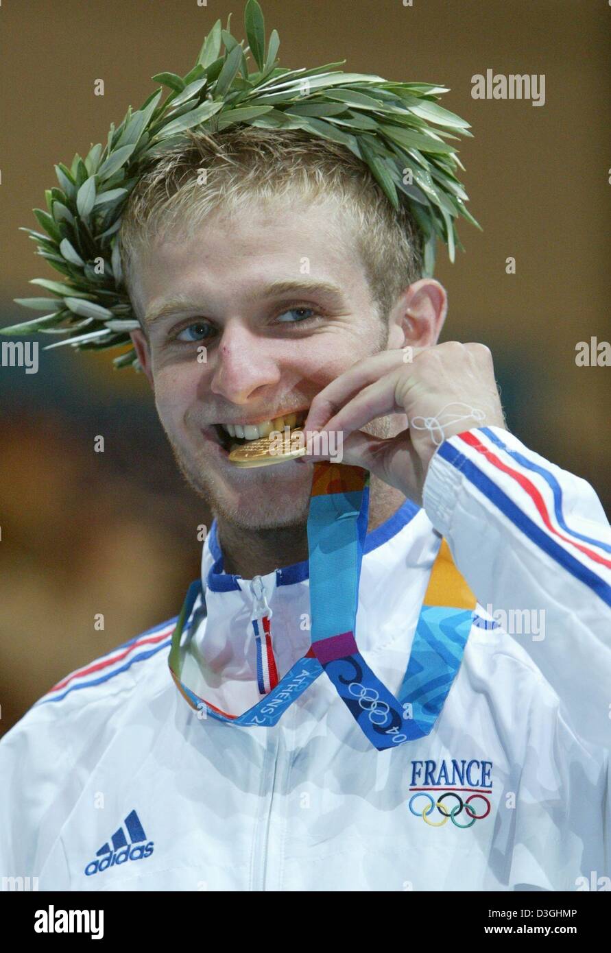 (dpa) - Brice Guyart from France bites into his gold medal on the ...