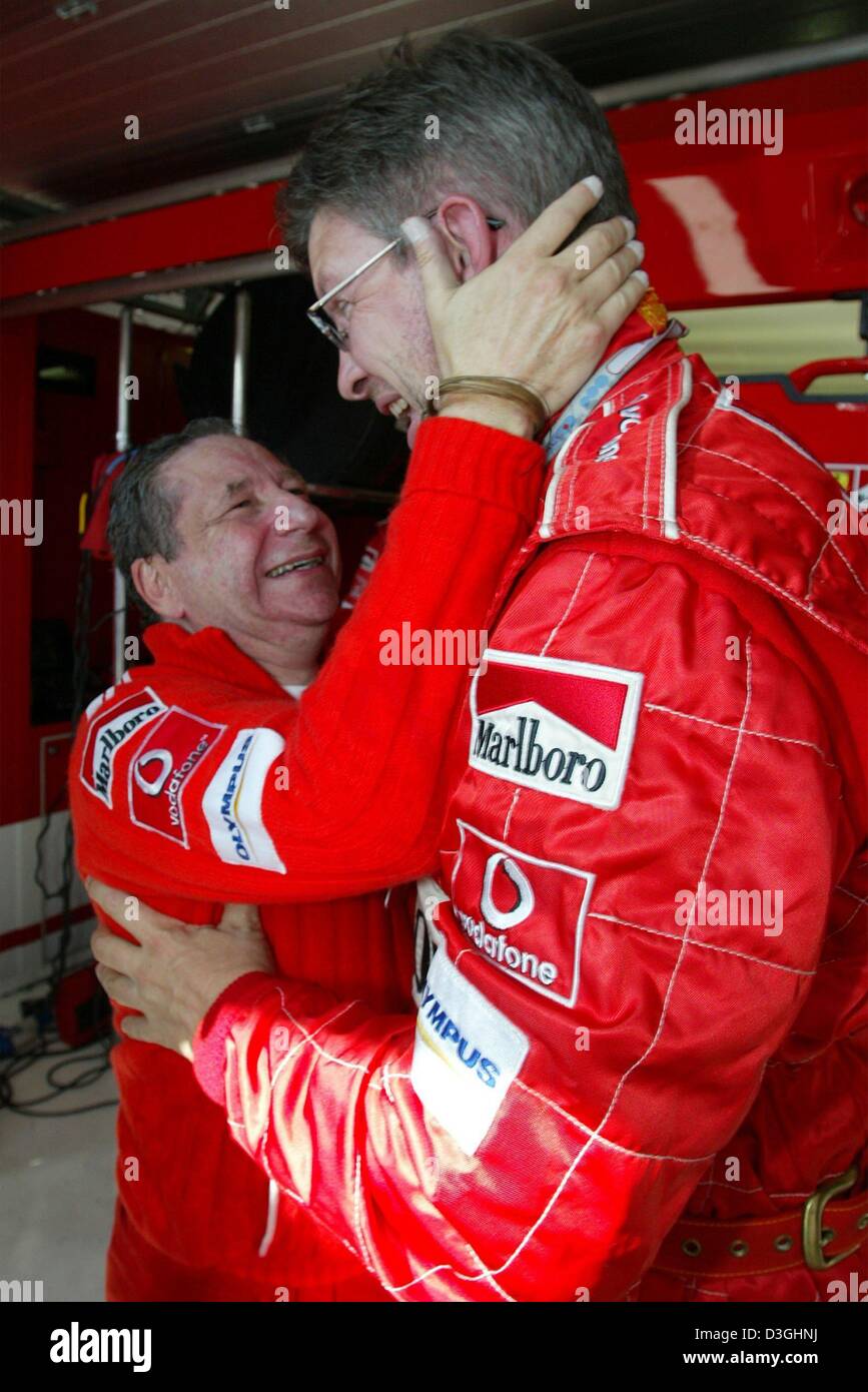 (dpa) - Ferrari's team leader Jean Todt (L) and his technical director Ross Brawn e,bracce each ...