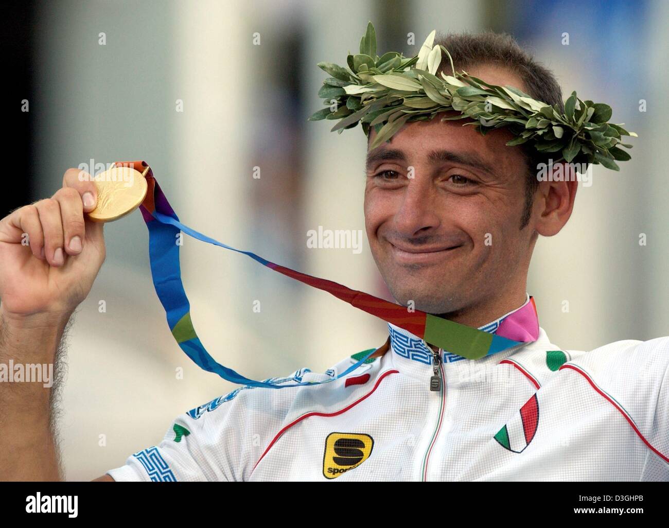 (dpa) - Italian cyclist Paolo Bettini smiles as he presents his gold ...