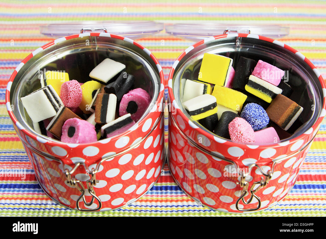 Liquorice sweets in colourful containers against a colourful background ...