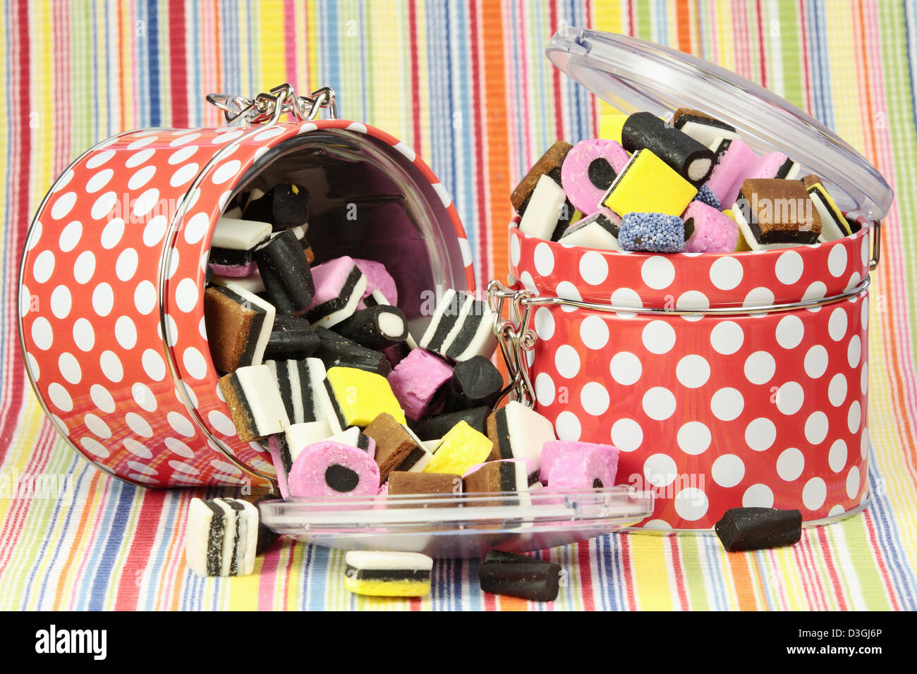 Liquorice sweets in colourful containers against a colourful background ...
