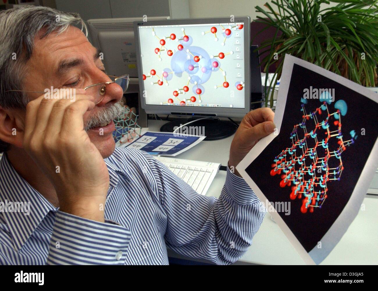(dpa) - Physics Professor Friedhelm Bechstedt studies the printout of a ...