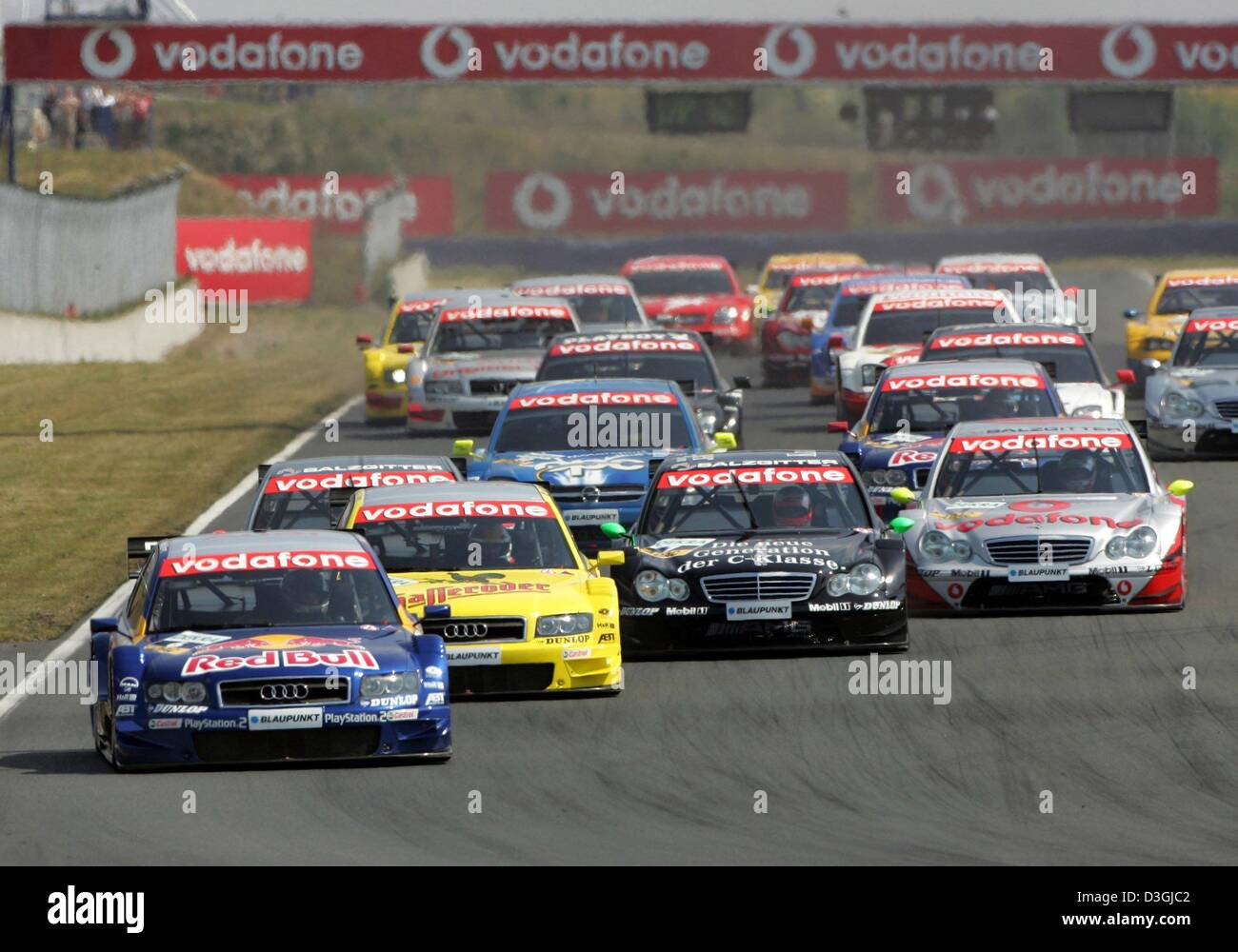 (dpa) - The field of DTM cars race along the racetrack shortly after ...