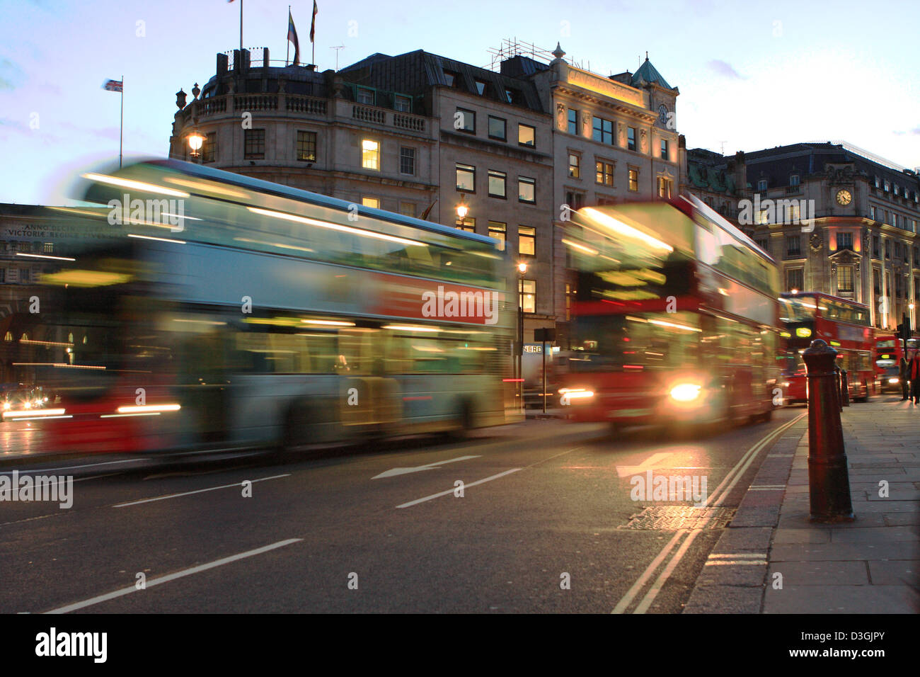 Double decker London buses traveling around Trafalgar Square one ...