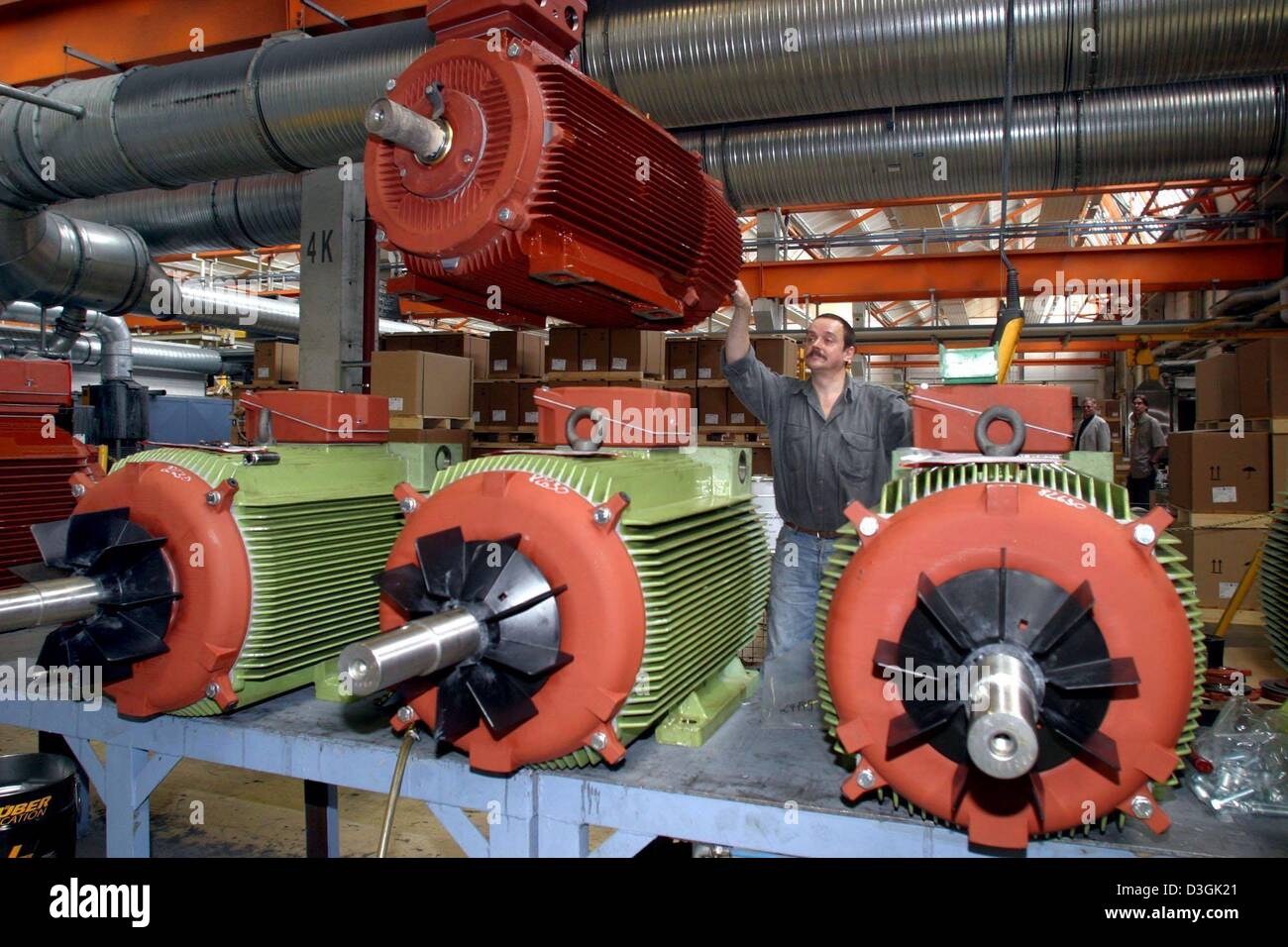 (dpa) - Employee Thomas Kluck prepares electric motors for packaging at ...