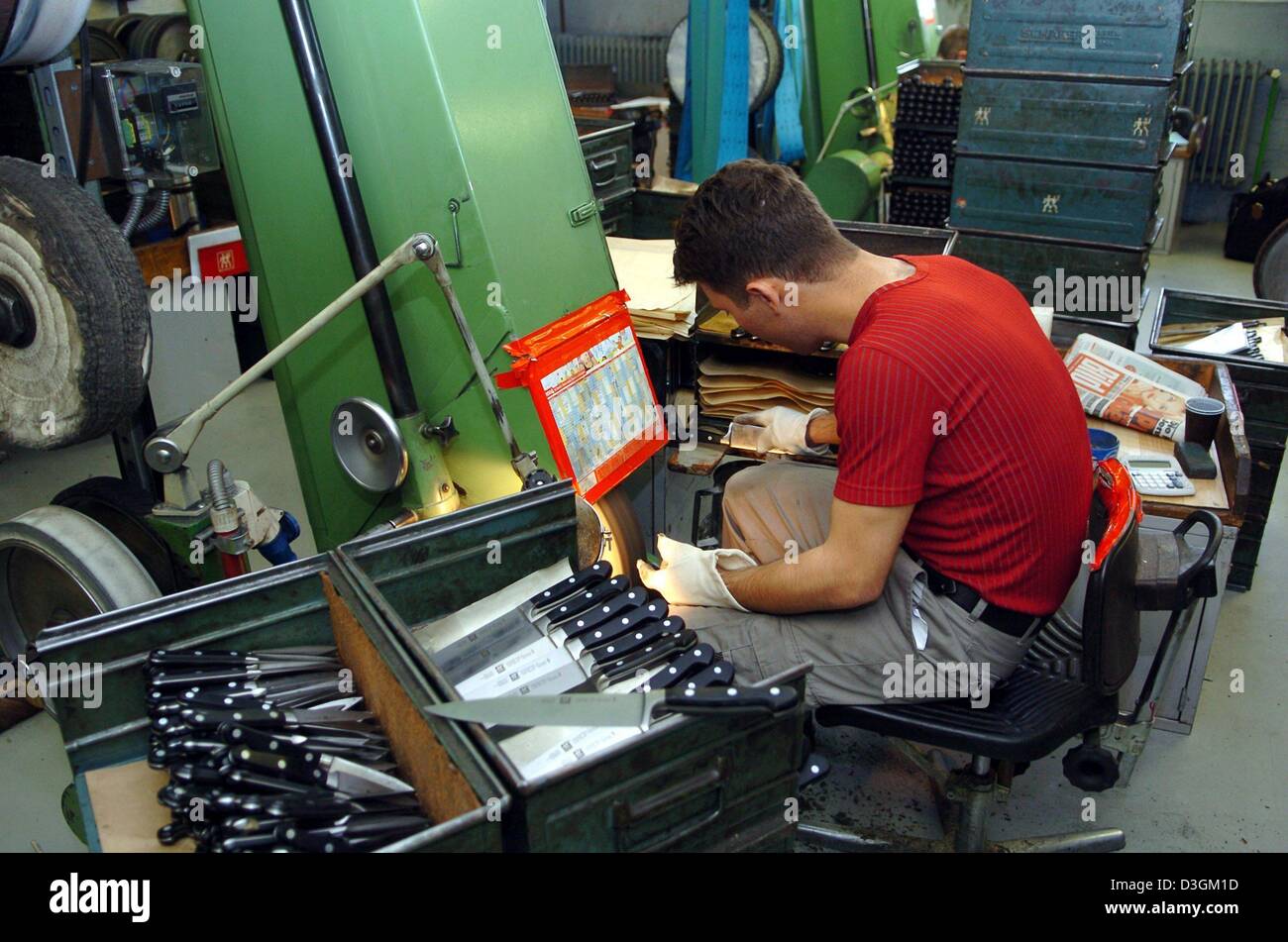 (dpa) - An employee grinds knives at the knife production plant of ...