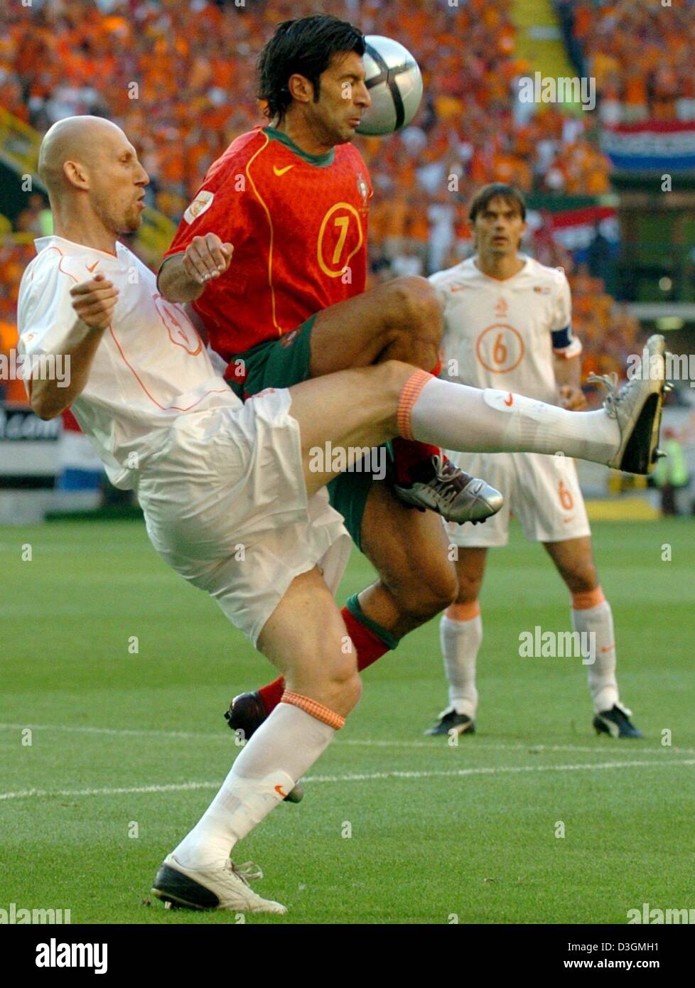 (dpa) - Portuguese team captain Luis Figo (R) fights for the ball with ...