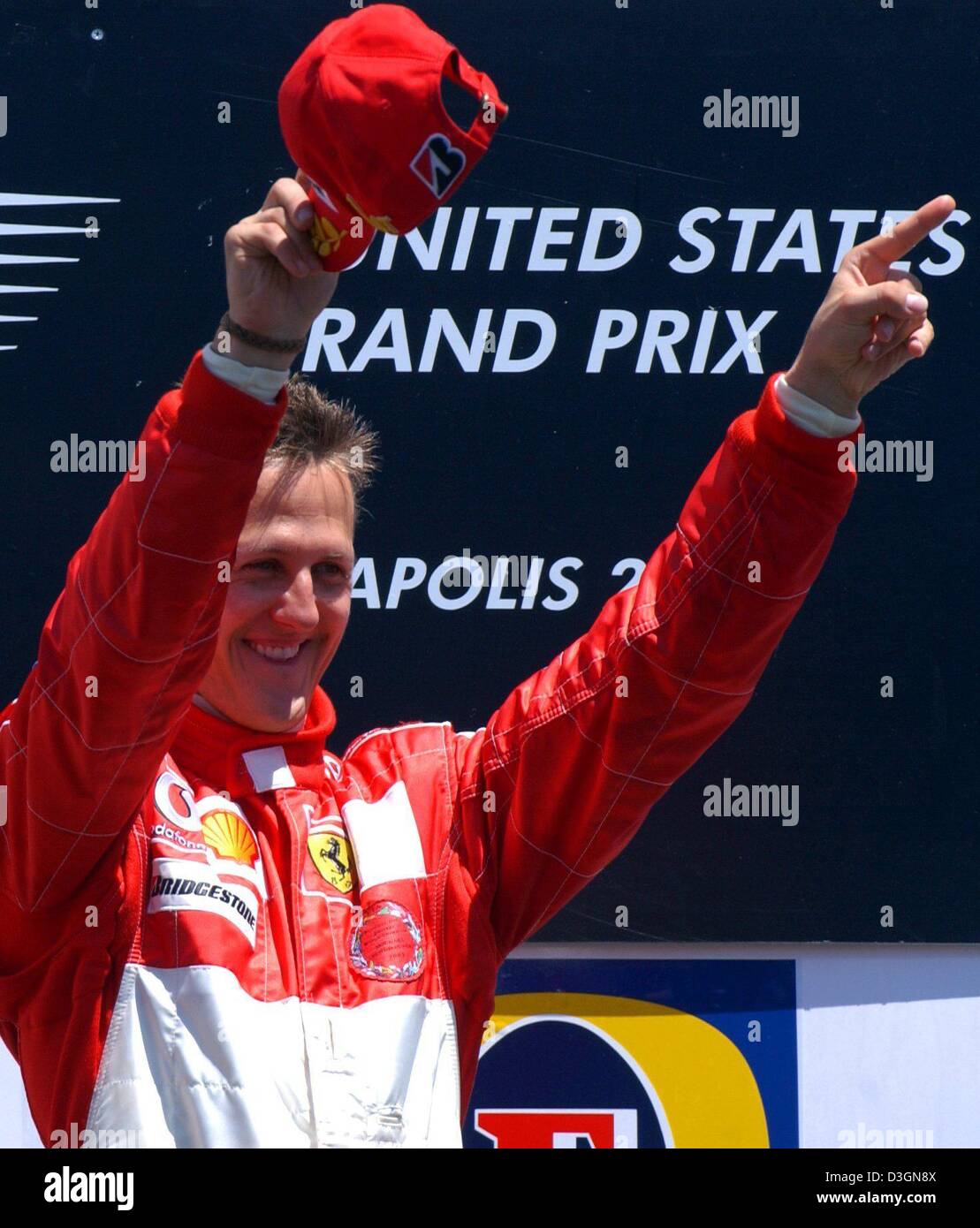 (dpa) - German formula pilot Michael Schumacher of Ferrari cheers and ...