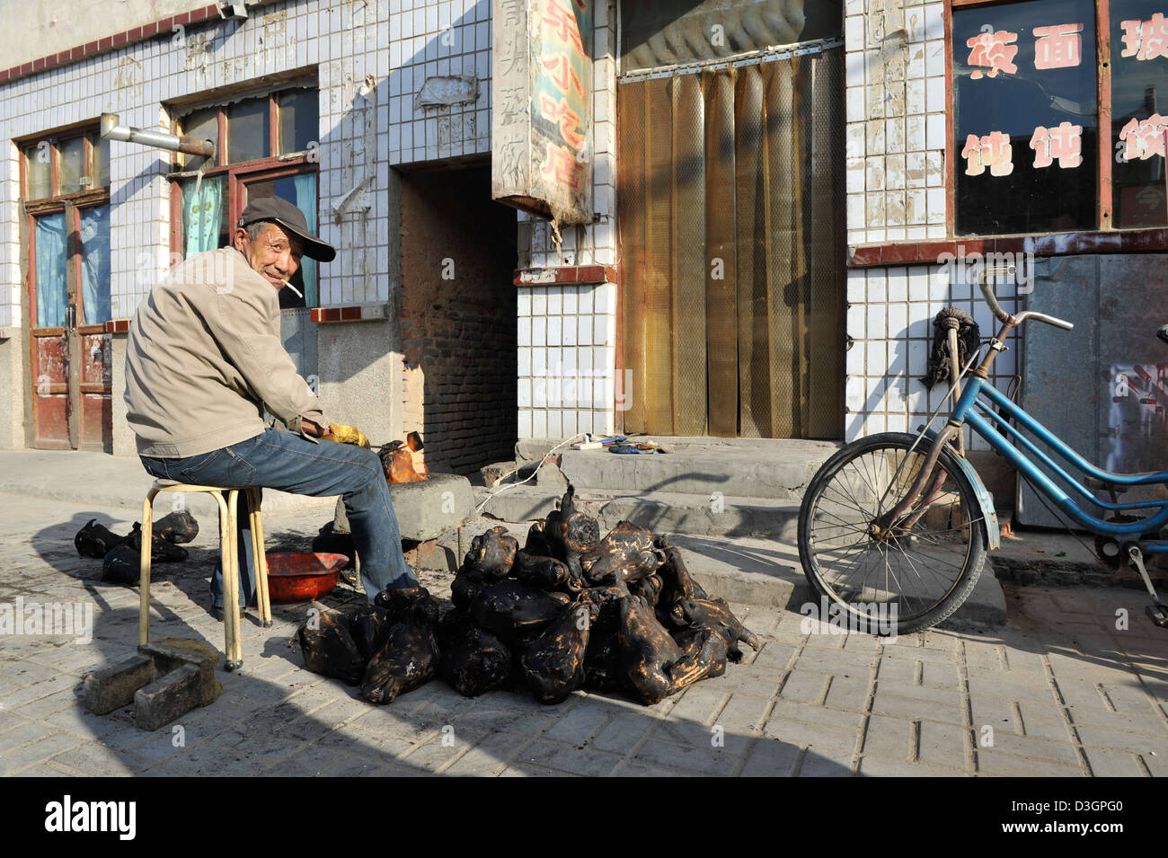 burning lambs heads in the street Stock Photo - Alamy