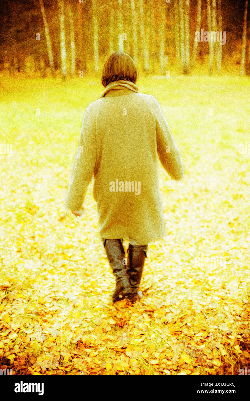 Woman Walking in field Stock Photo - Alamy