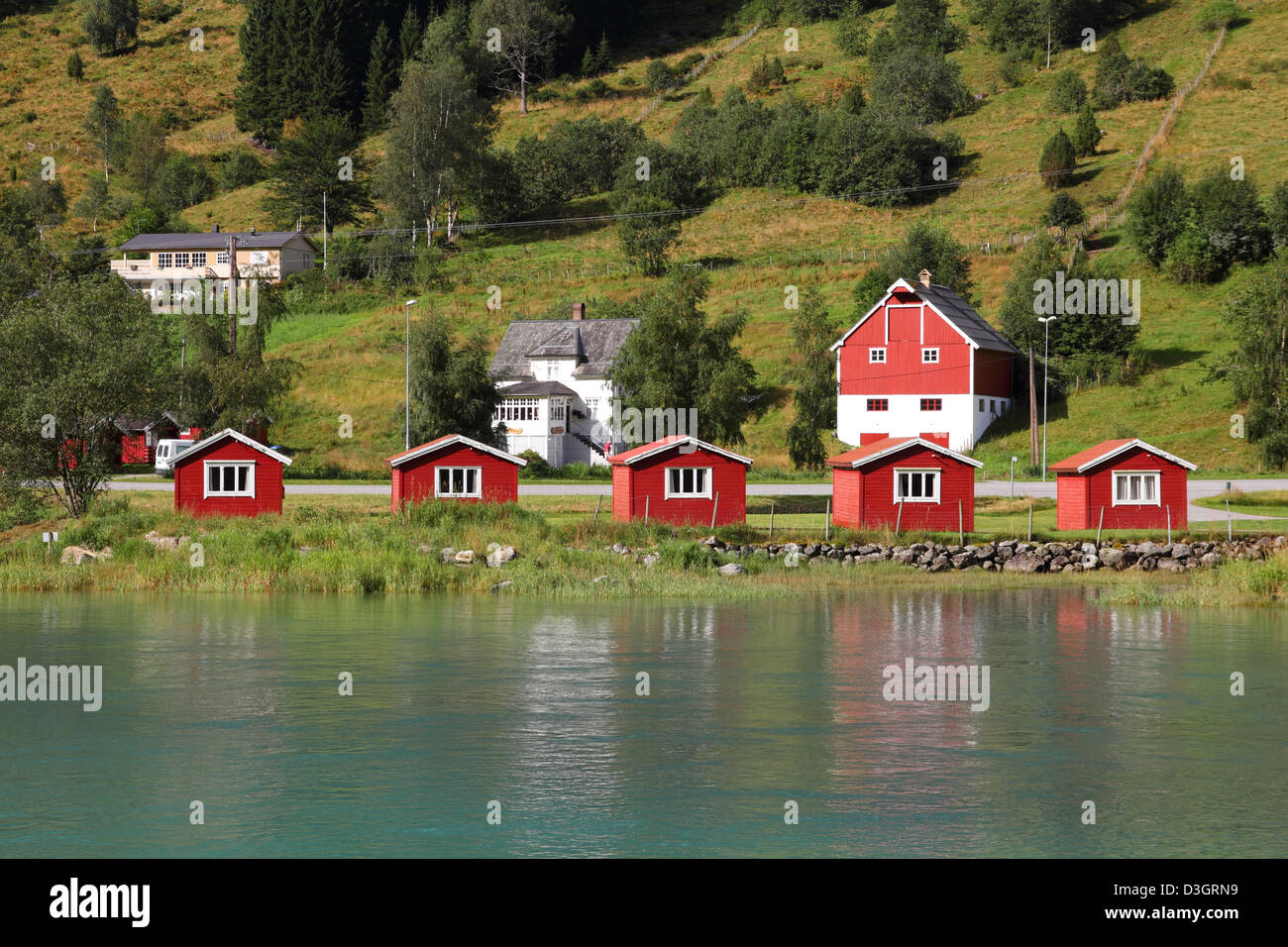 Norway, Sogn of Fjordane county. Small red cabins next to Nordfjord in ...