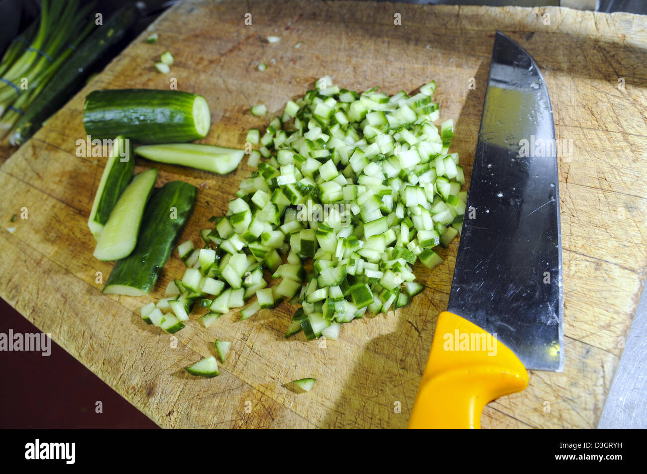 Diced cucumber with knife and chopping board Stock Photo - Alamy